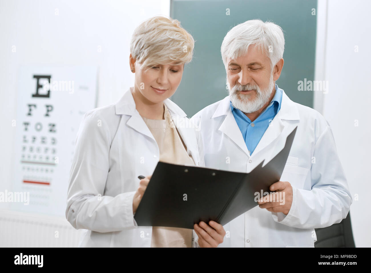 Two ophthalmologist consulting one with another in medical laboratory ...