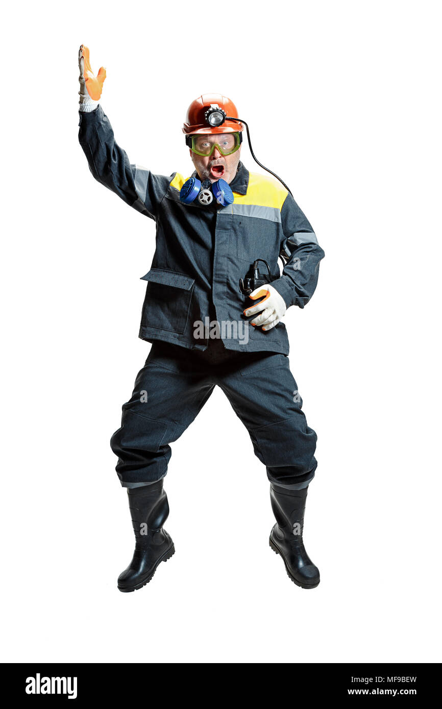 The studio shot of senior bearded male miner standing at the camera on ...