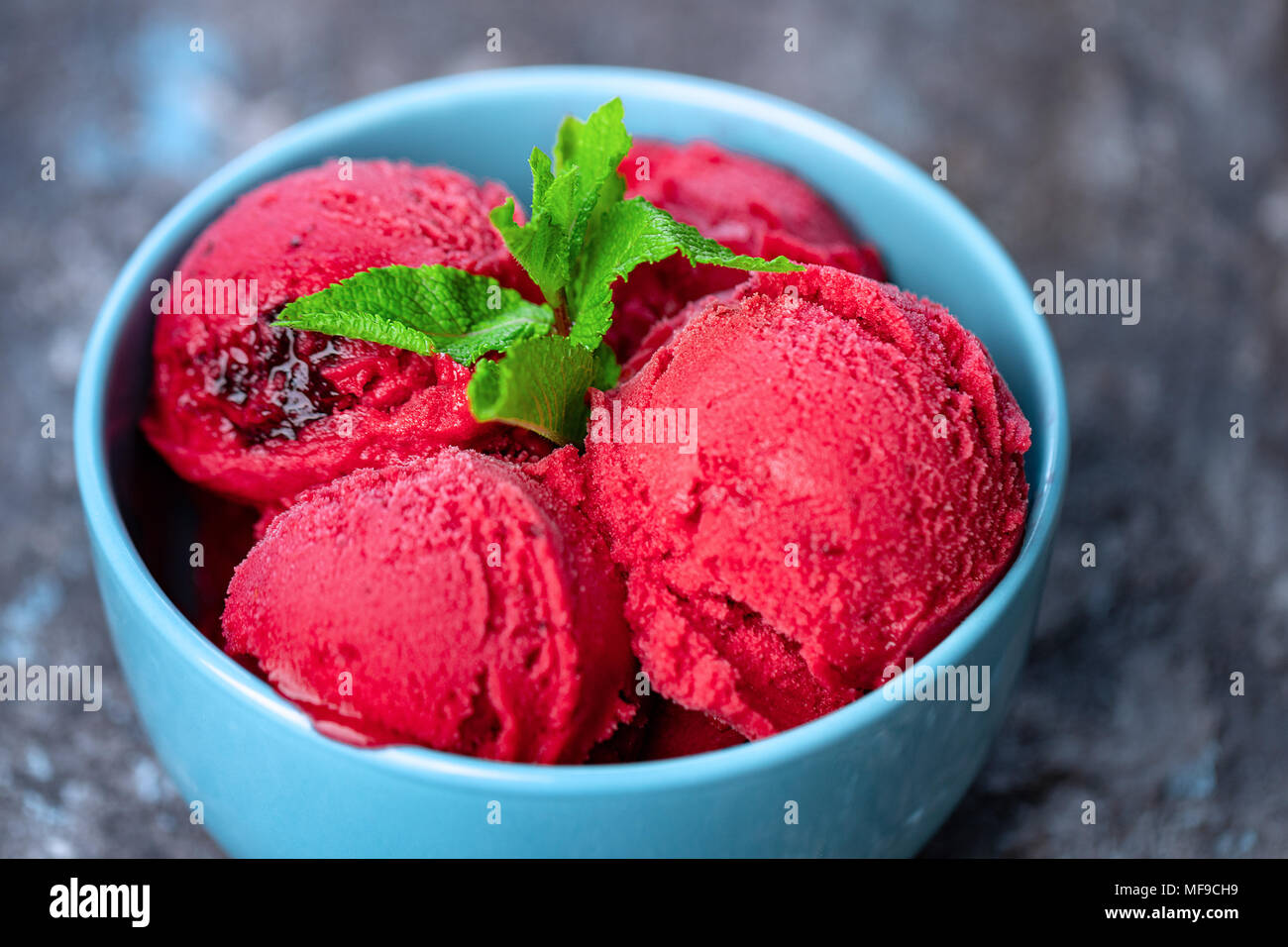 Raspberry ice cream in bowl on stone table Stock Photo - Alamy