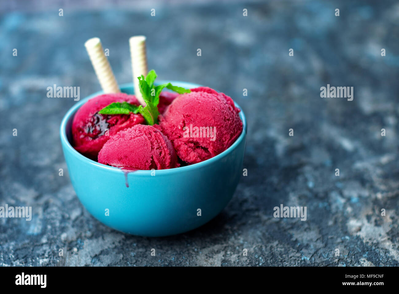 Raspberry ice cream in bowl on stone table Stock Photo - Alamy