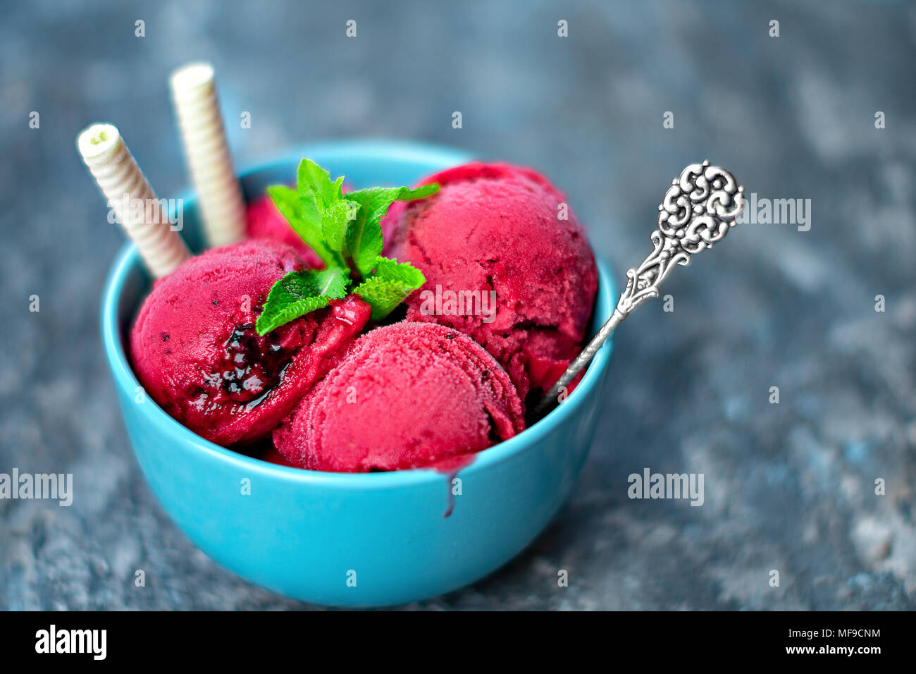 Raspberry ice cream in bowl on stone table Stock Photo - Alamy