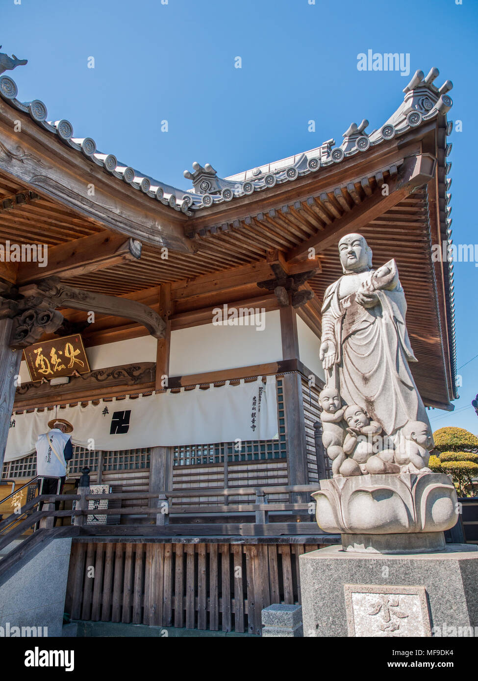 Statue of Jizo Bosatsu and henro pilgrim praying, Kanonji, temple 16 ...