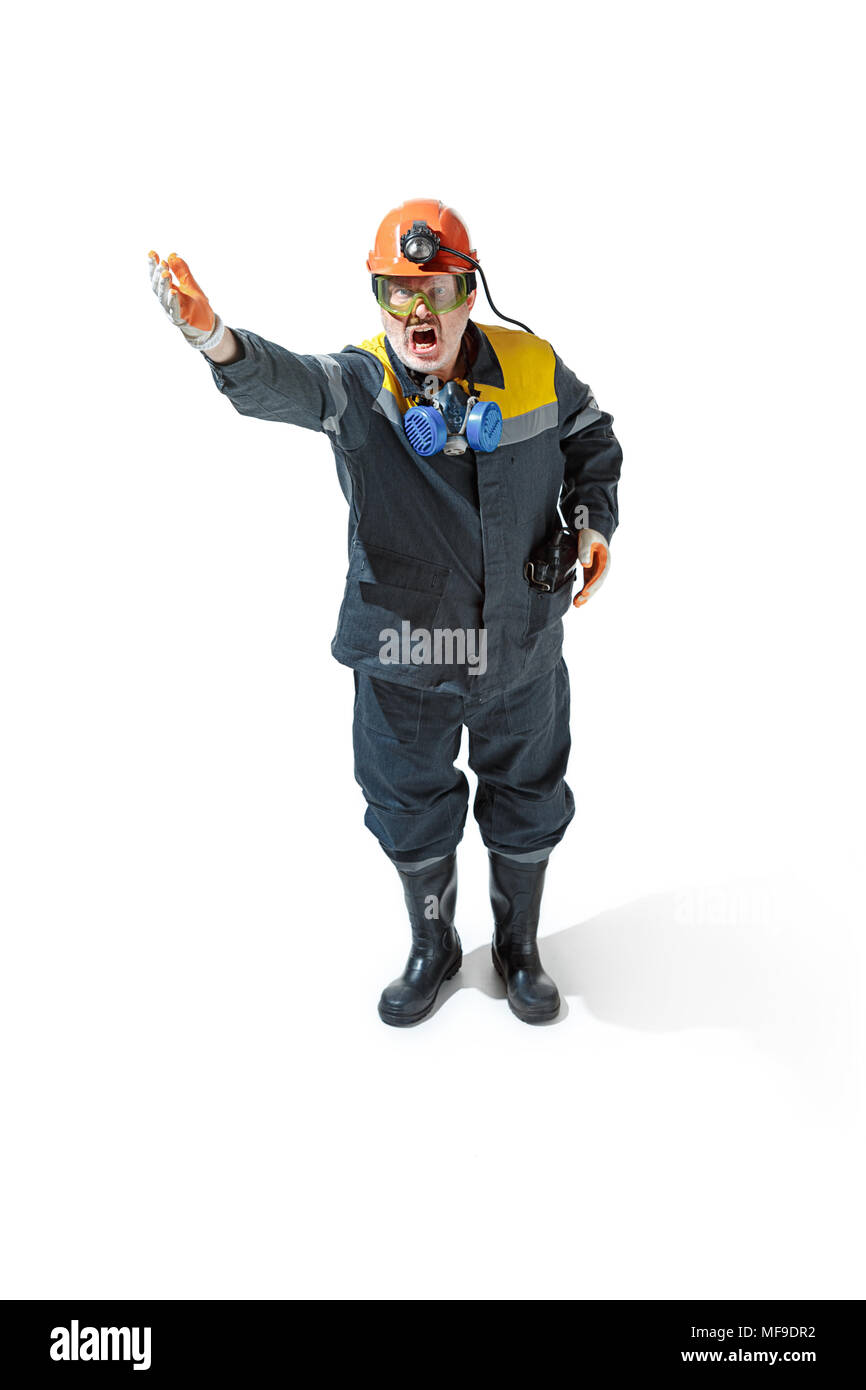 The studio shot of senior bearded male miner standing at the camera on ...