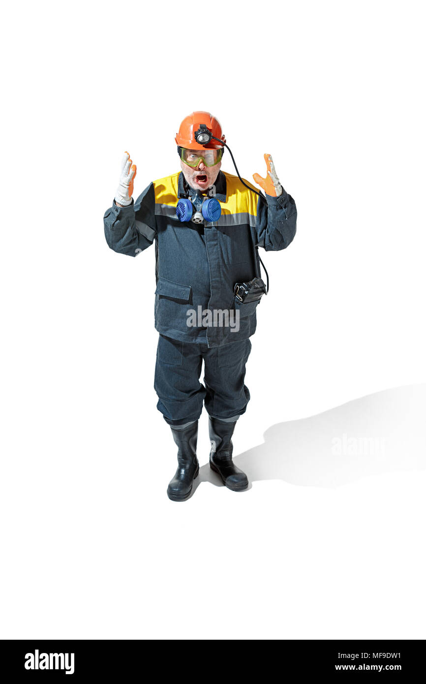 The studio shot of senior bearded male miner standing at the camera on ...