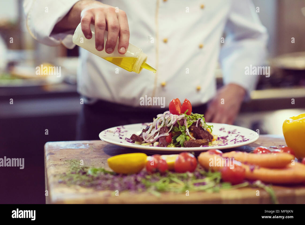Chef finishing steak meat plate with Finally dish dressing and almost ...