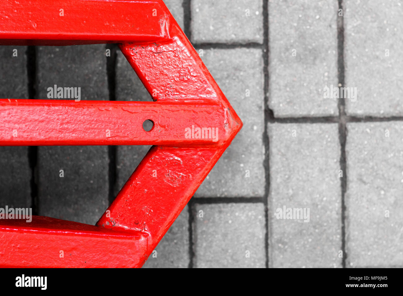 red arrow on the road. Red pointer, iron construction in the form of a ...