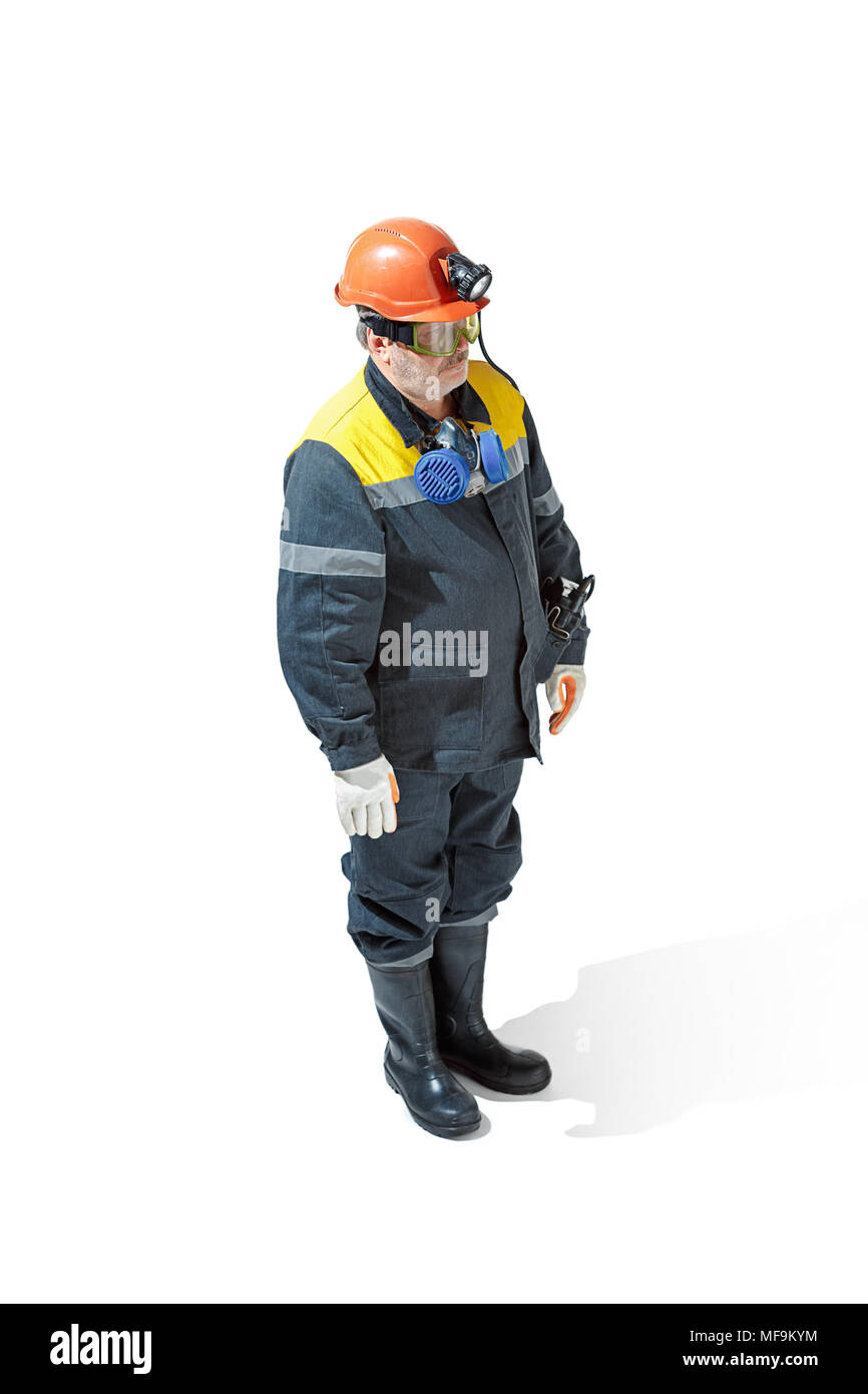 The studio shot of senior bearded male miner standing at the camera on ...