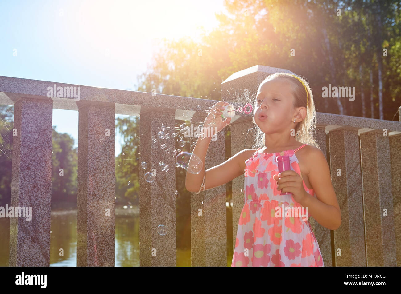 Child blowing soap bubbles. Girl playing outdoors Stock Photo - Alamy Child blowing soap bubbles. Girl playing outdoors Stock Photo - Alamy
