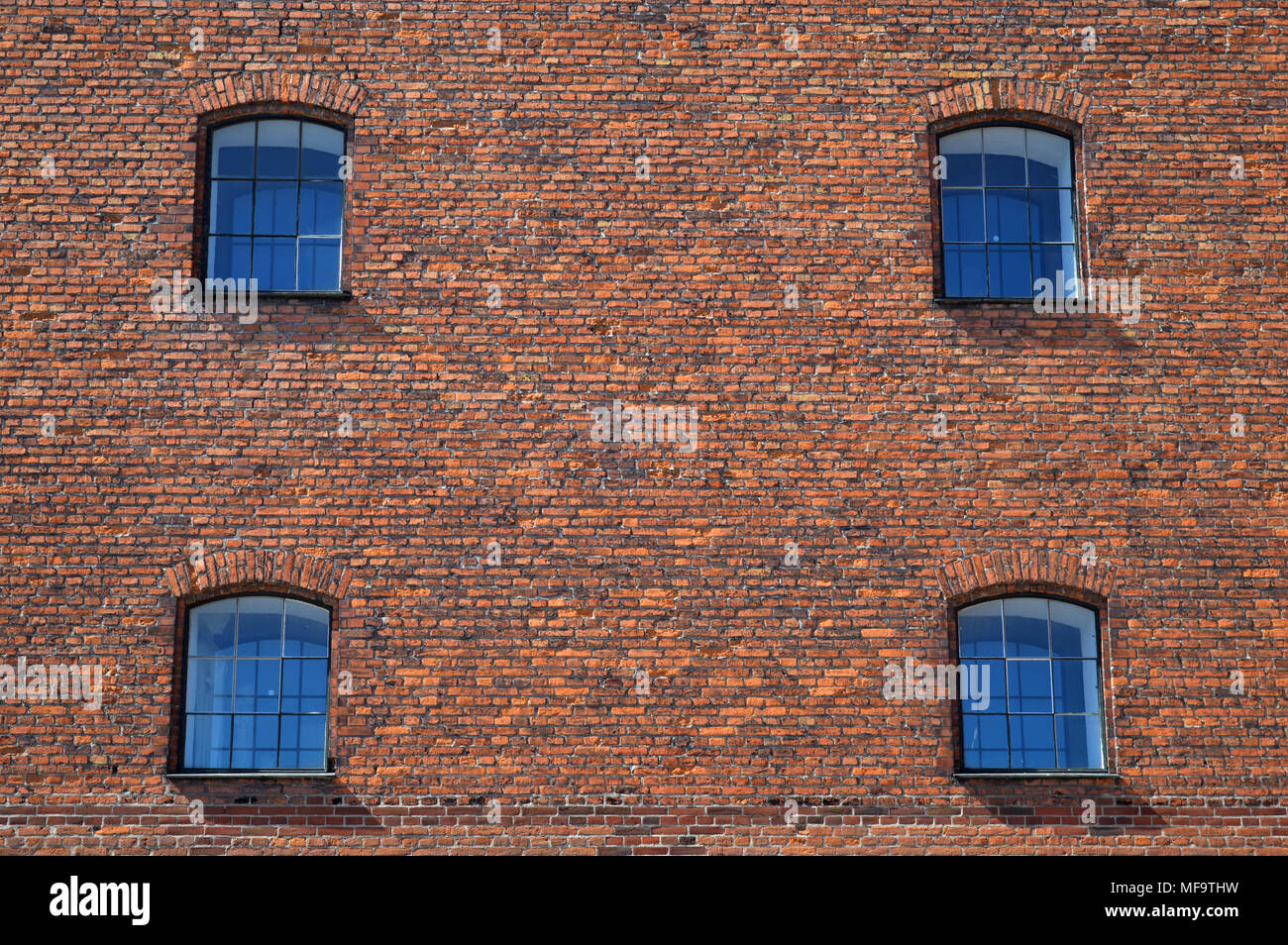 Windows and brick wall symmetry Stock Photo - Alamy
