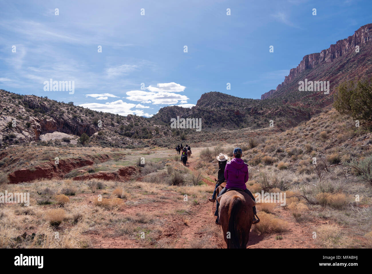 Tourists enjoy a trail ride with staff from Red Cliffs Lodge, near Moab ...