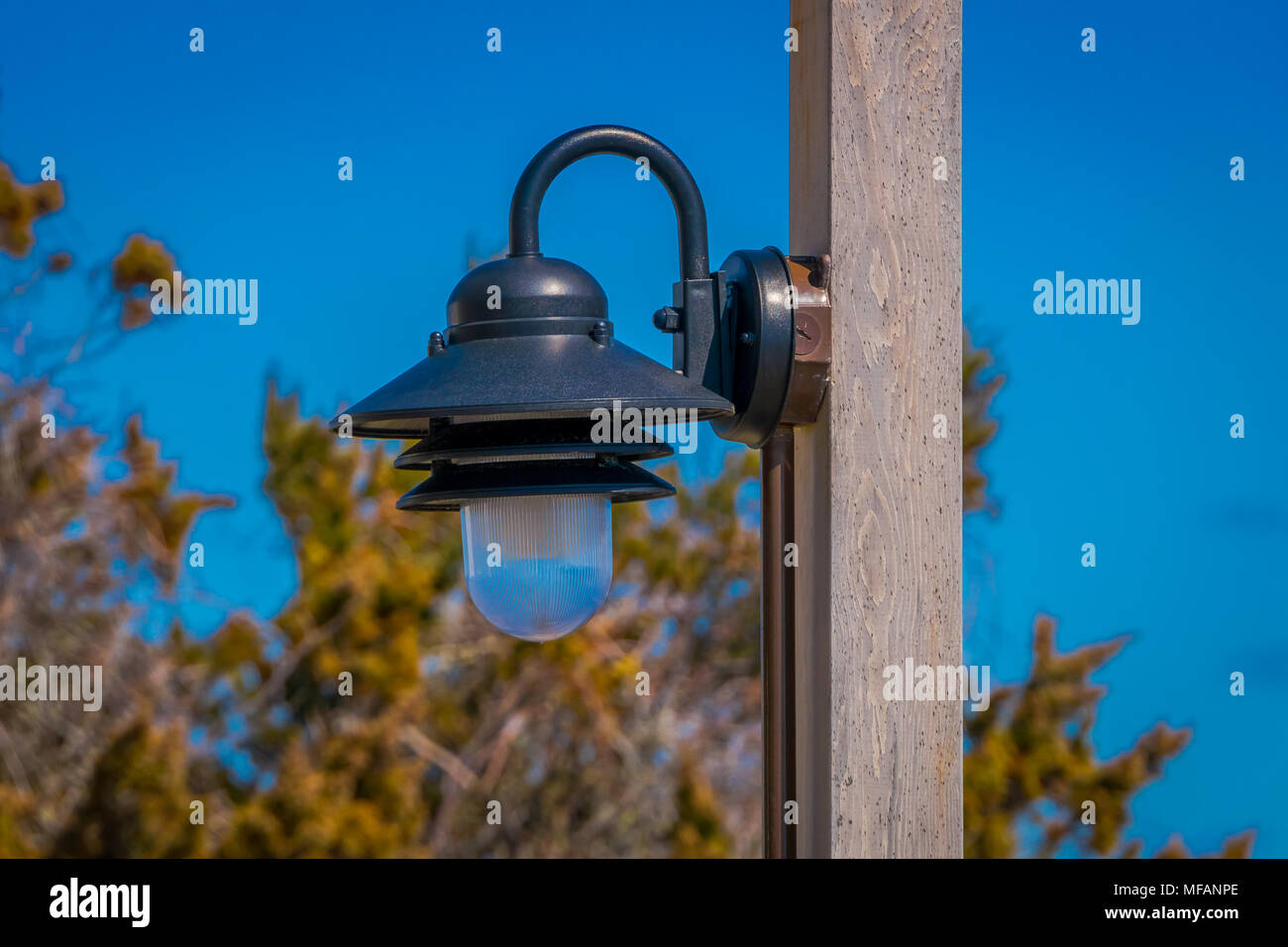 Outdoor view of light lamps in a wooden post with gorgeous blue sky in ...