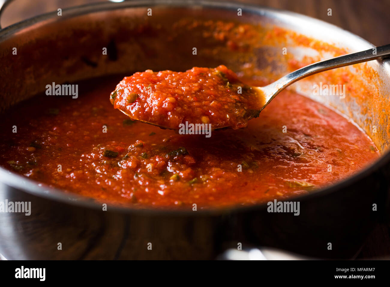 Metal spoon in sauce hi-res stock photography and images - Alamy