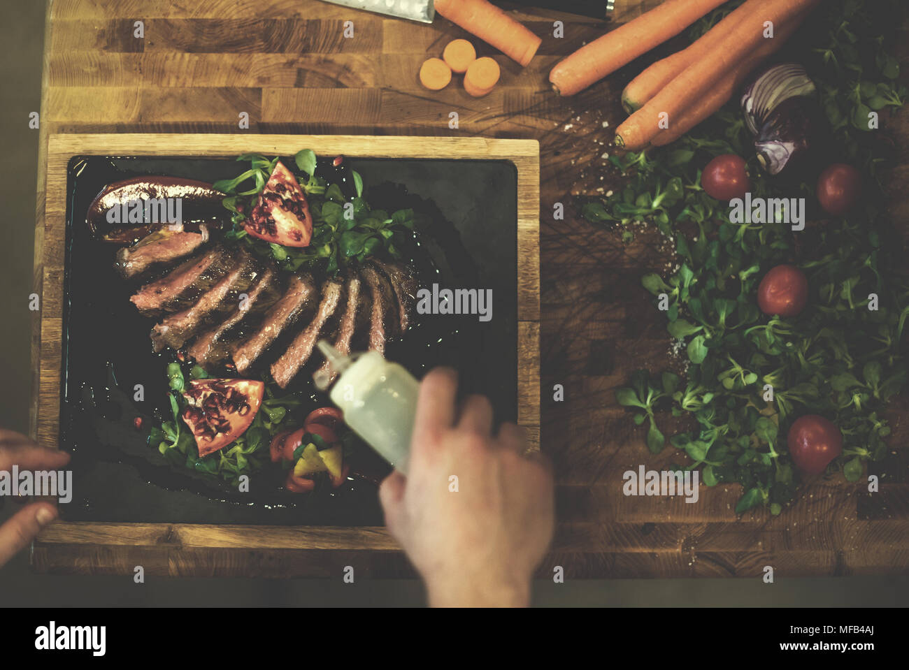 Chef finishing steak meat plate with Finally dish dressing and almost ...