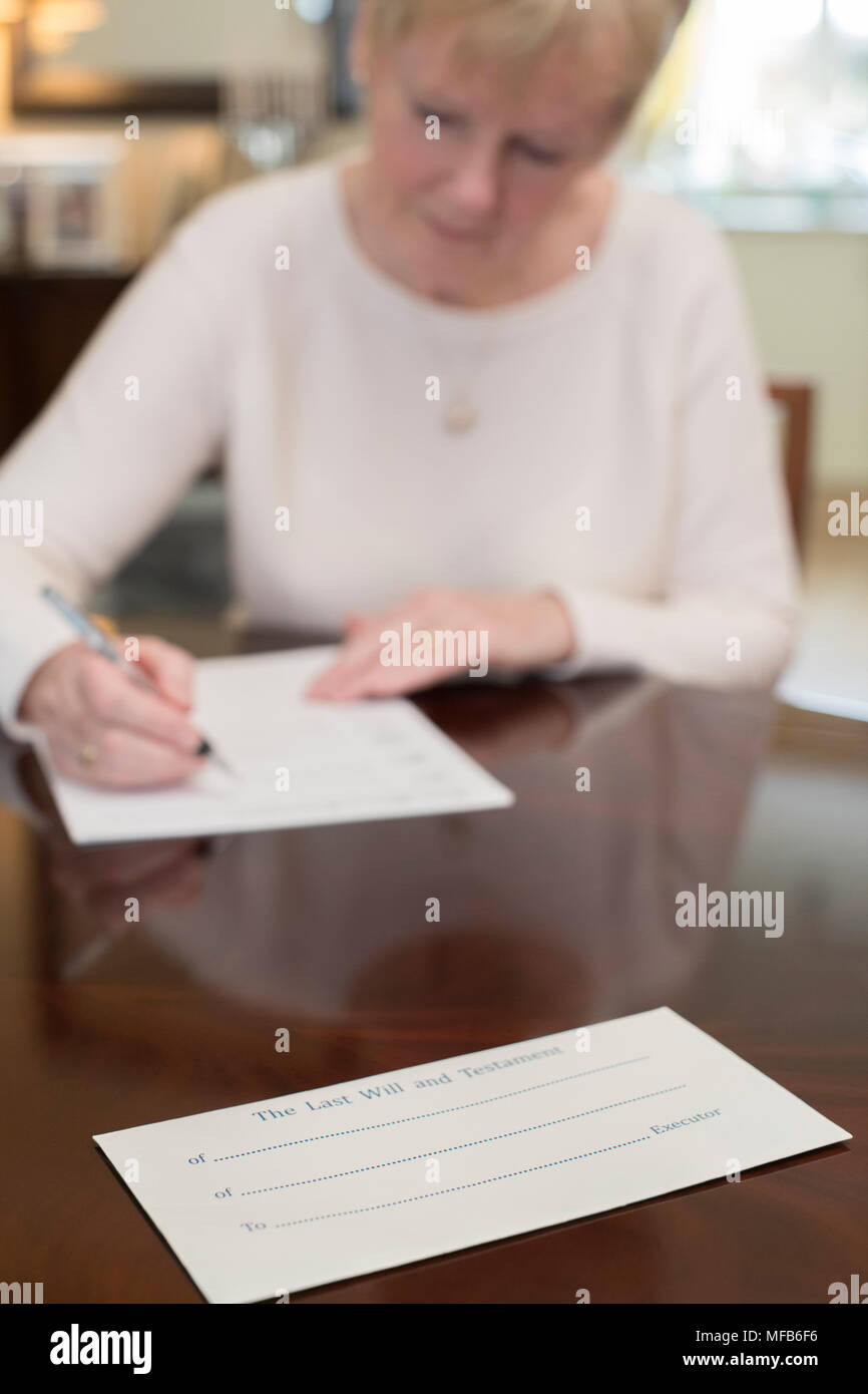 Old woman signing agreement hi-res stock photography and images - Alamy