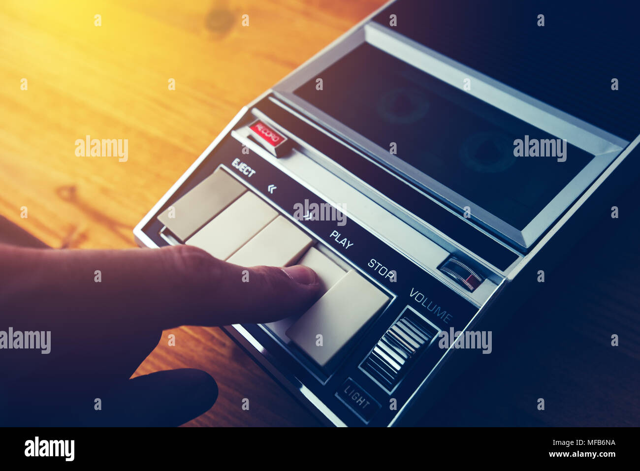 Playing audio cassette in vintage player, retro technology concept ...