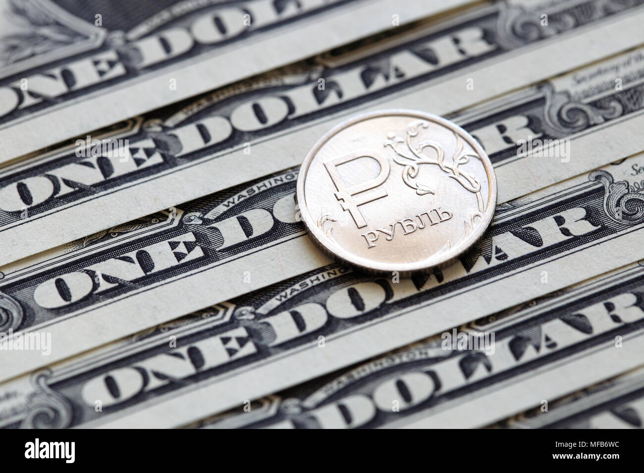 Russian ruble coin on one dollar bills background Stock Photo - Alamy