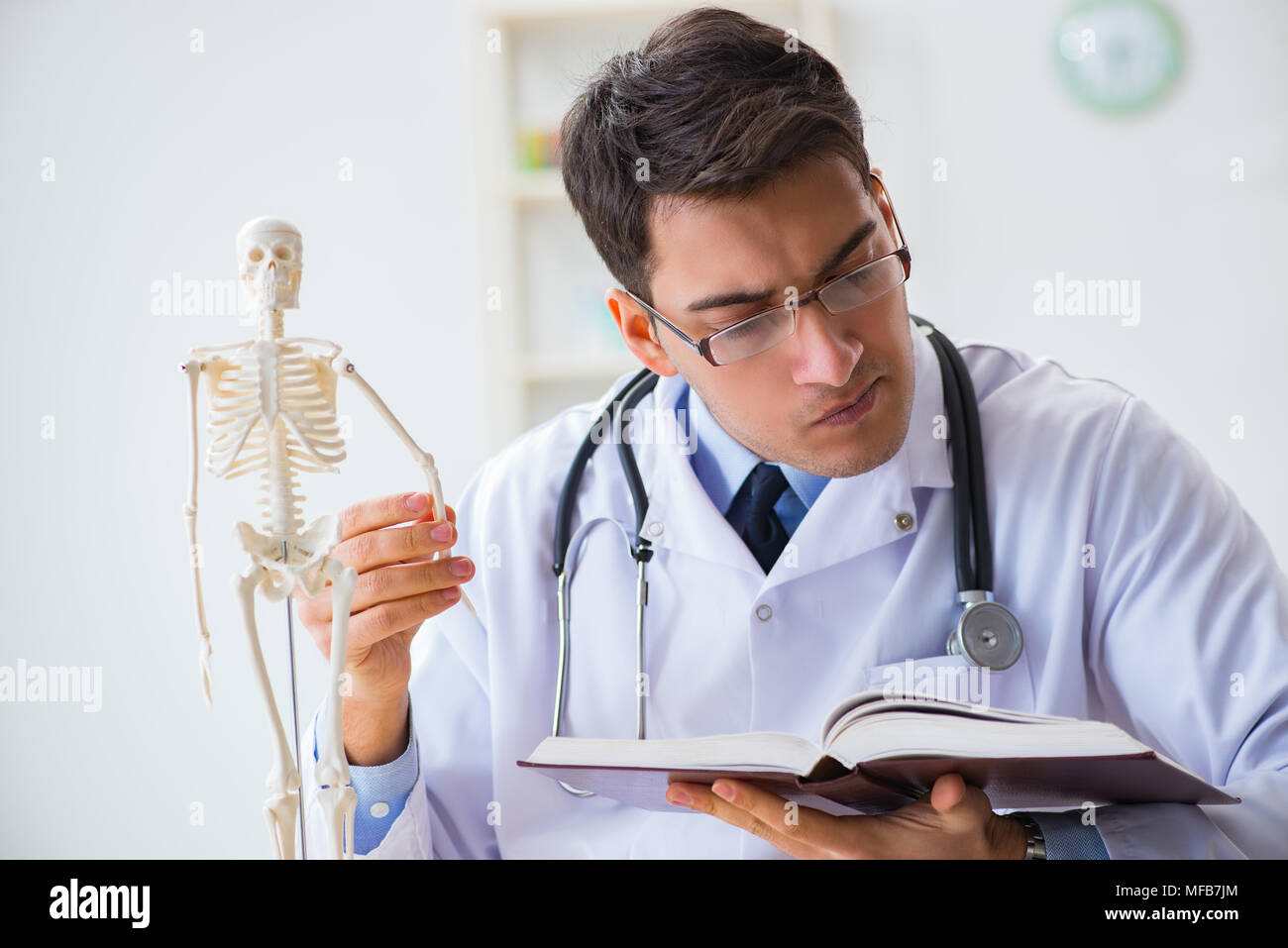 Doctor student studying the bones of skeleton Stock Photo - Alamy