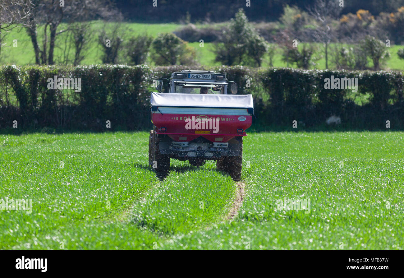 Tractor spreading fertilizer on field Stock Photo - Alamy