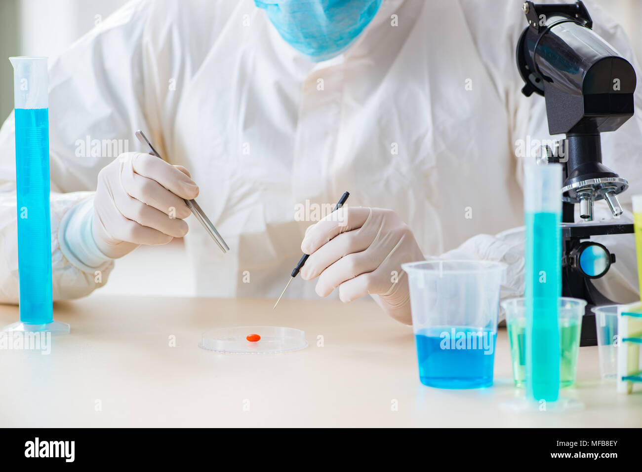 Lab assistant in drug synthesis concept Stock Photo - Alamy