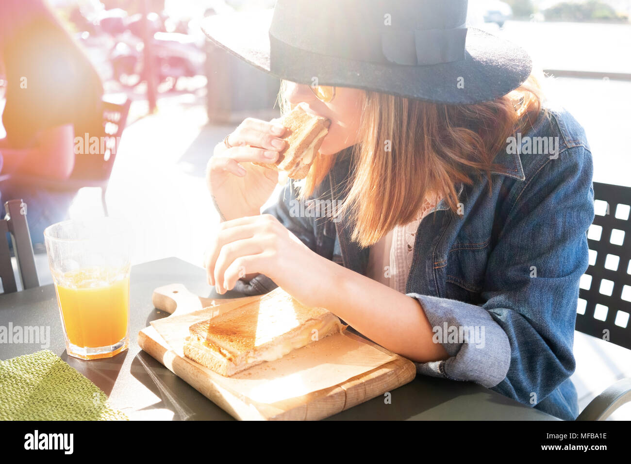 Young woman eating toast model hi-res stock photography and images - Alamy