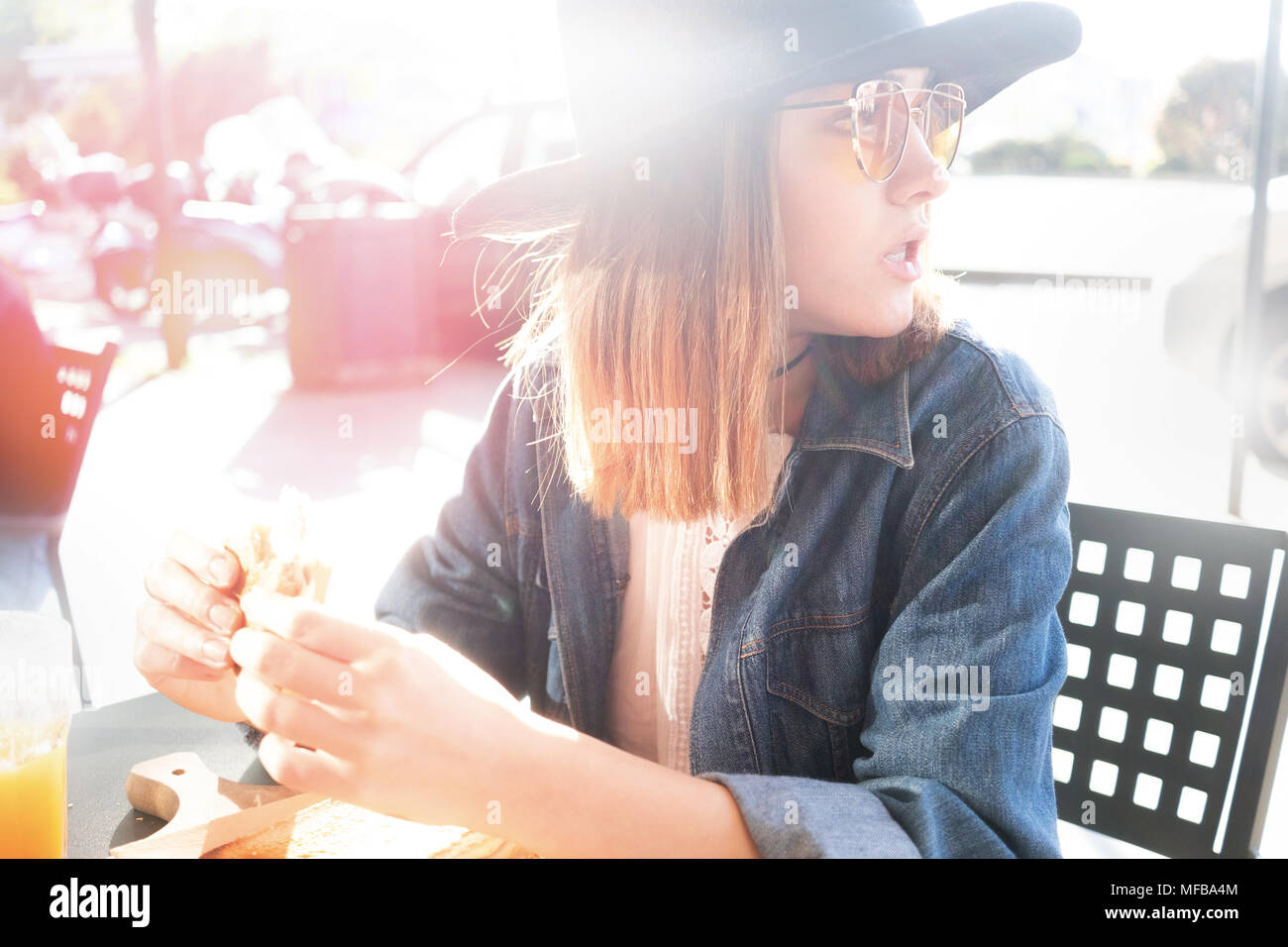 Young woman eating toast model hi-res stock photography and images - Alamy
