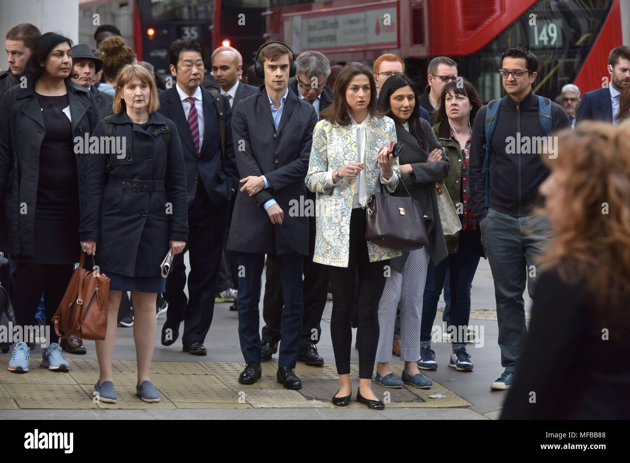 Office workers commuting to work during the morning rush hour in the ...