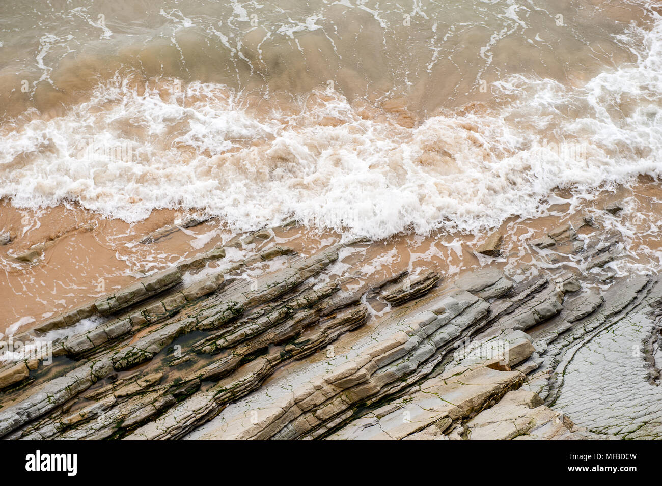 Sea and the rock over the sand beach Stock Photo - Alamy