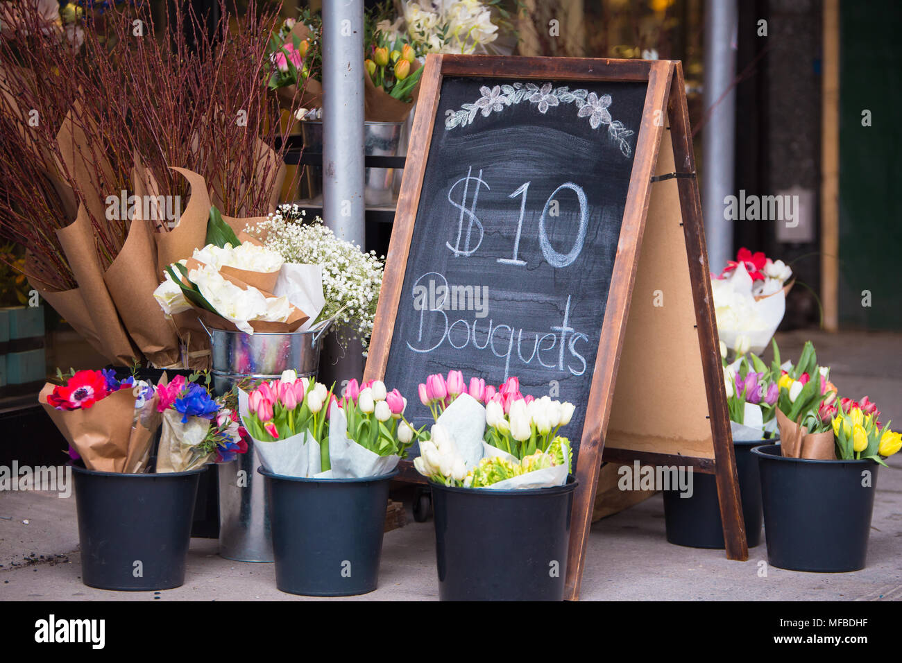 Charming florist sidewalk display of flowers and sign Stock Photo - Alamy