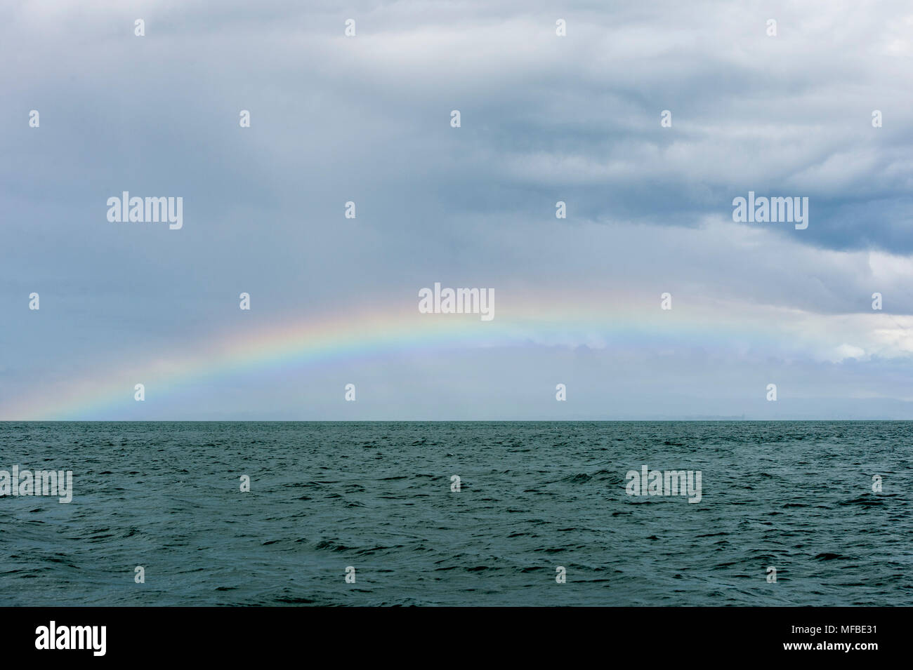 Rainbow at sea Stock Photo - Alamy