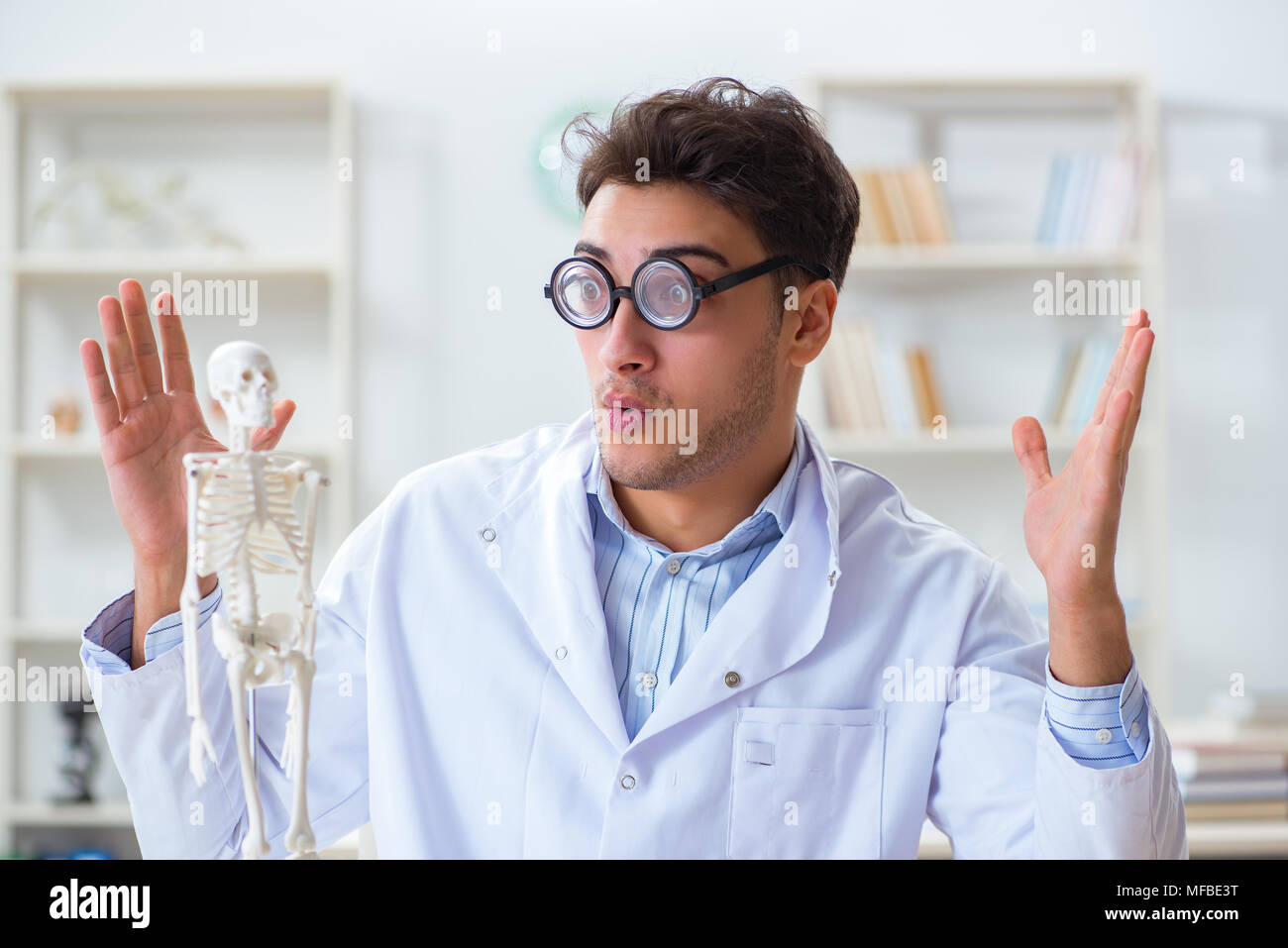 Crazy doctor studying human skeleton Stock Photo - Alamy