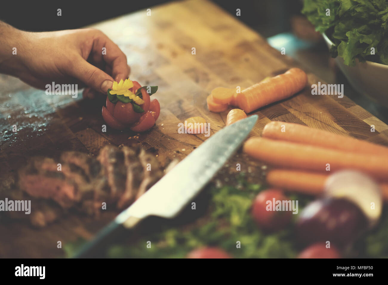 closeup of Chef hands in hotel or restaurant kitchen preparing beef ...