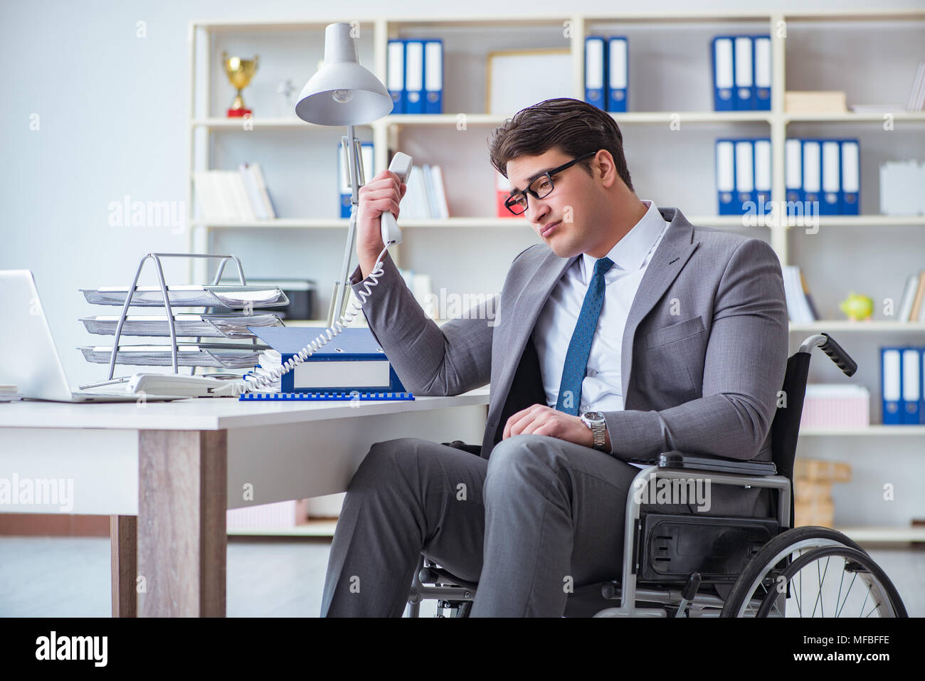 Disabled businessman working in the office Stock Photo - Alamy