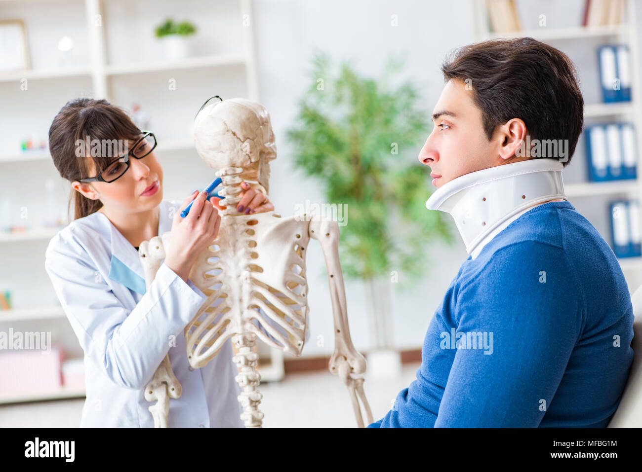 Doctor is explaining to patient with neck injury Stock Photo - Alamy