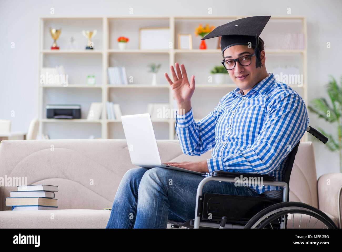 Young student on wheelchair in disability concept Stock Photo - Alamy