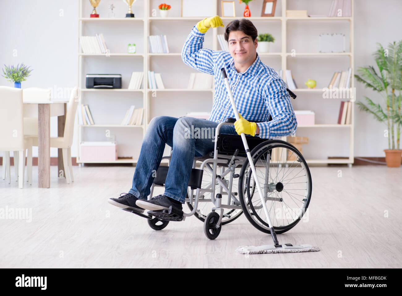 Disabled man on wheelchair cleaning home Stock Photo - Alamy