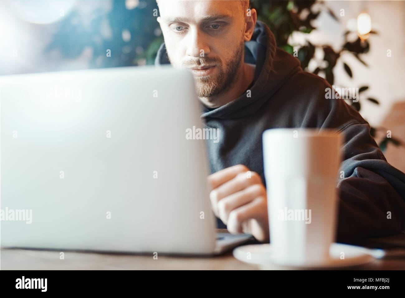 Young man working on PC pc in co-working Stock Photo - Alamy