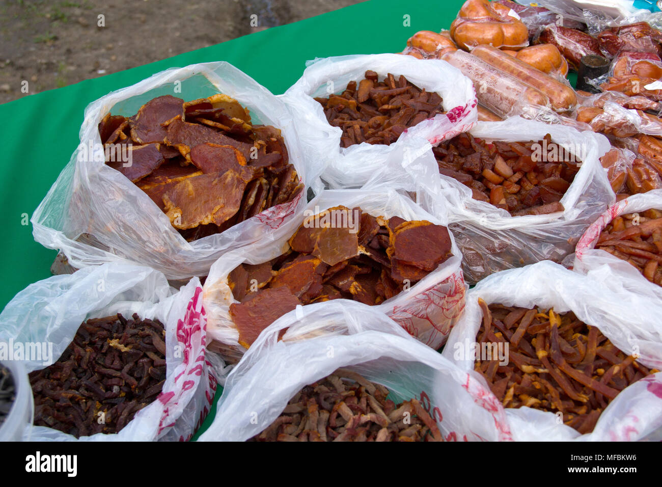 Cured meats of different varieties and sizes are in white bags Stock ...