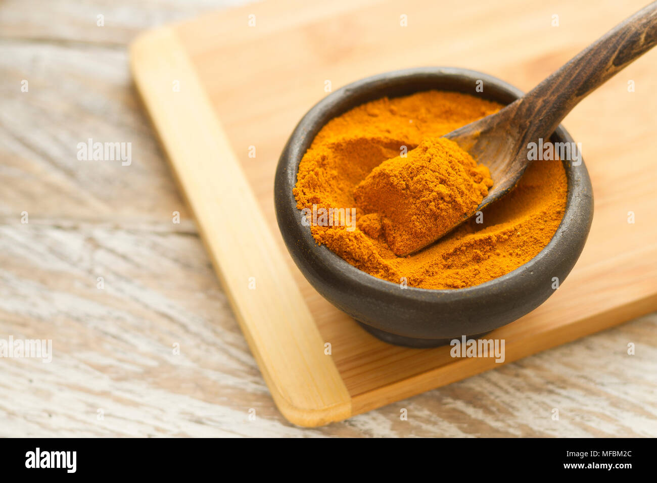 Ground turmeric in a bowl on wooden background- turmeric longa Stock ...