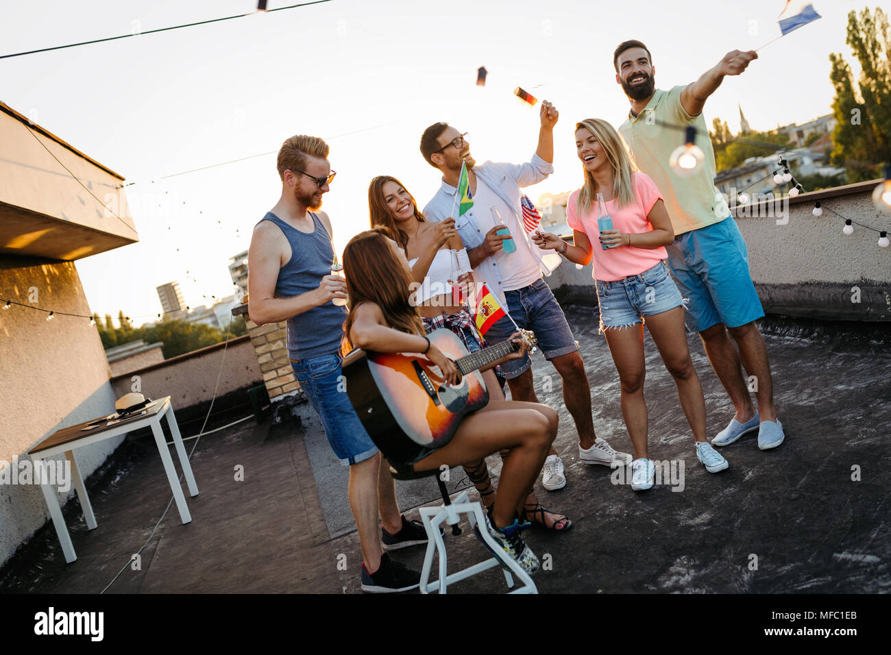 Friends having fun at rooftop party Stock Photo - Alamy