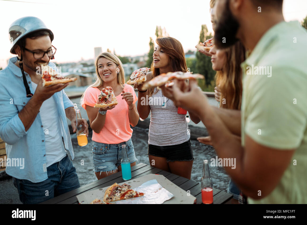 Table people pizza hi-res stock photography and images - Alamy
