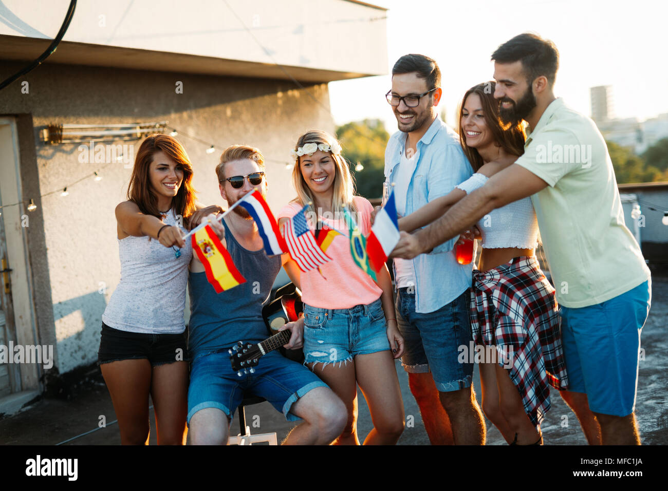 Group of happy friends having party on rooftop Stock Photo - Alamy