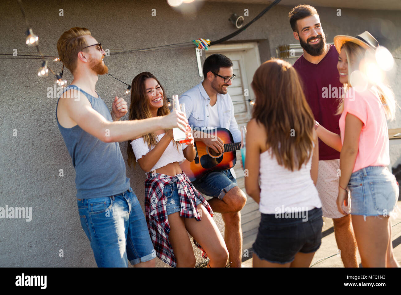 Group of happy friends having party on rooftop Stock Photo - Alamy