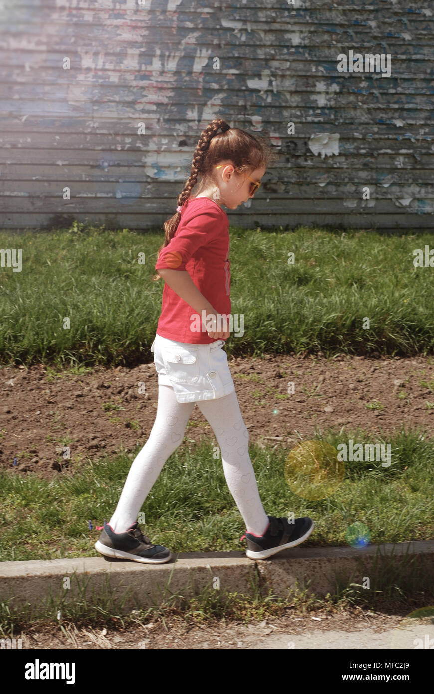 Caucasian Little girl 7 Yars Old Baby Girl Walking at Park Stock Photo ...