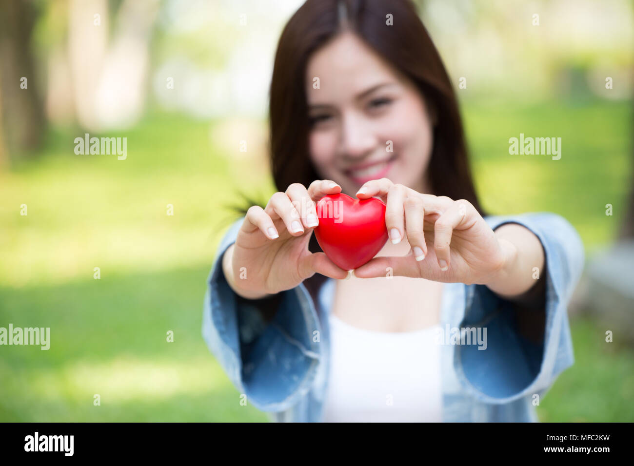 Giving Love together concept: Cute Asian woman hold red heart for ...