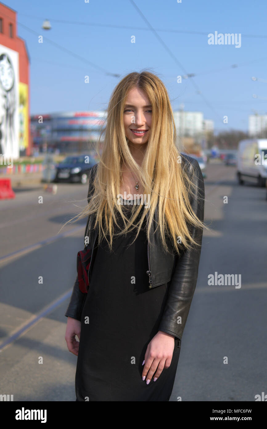 Pretty girl enjoying warm sun and wind Stock Photo - Alamy