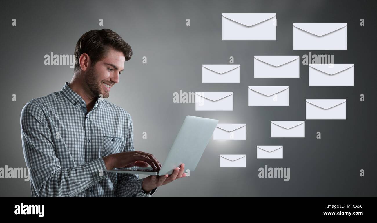 Envelope letter messages and man using laptop Stock Photo - Alamy