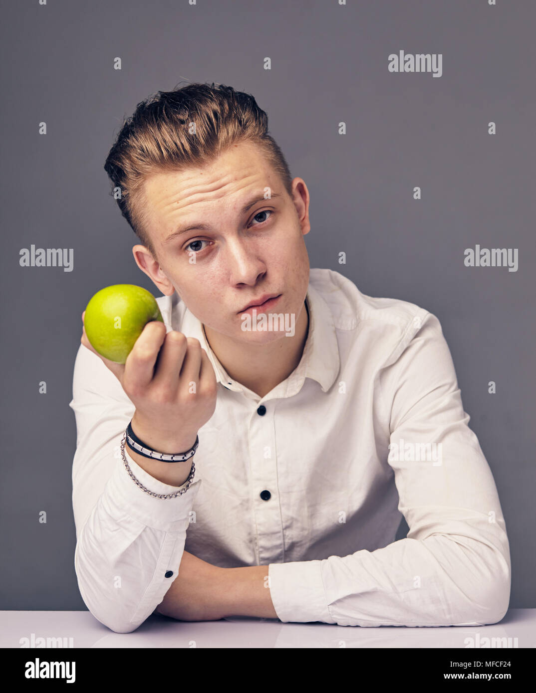 Portrait of young man with an apple hi-res stock photography and images ...