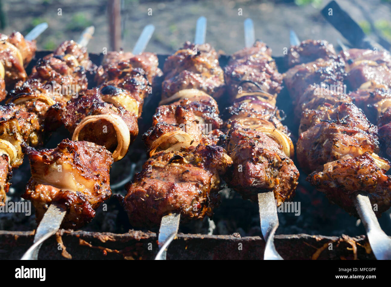 Meat on iron skewers, cooked on an open fire. Shish kebab roasted ...