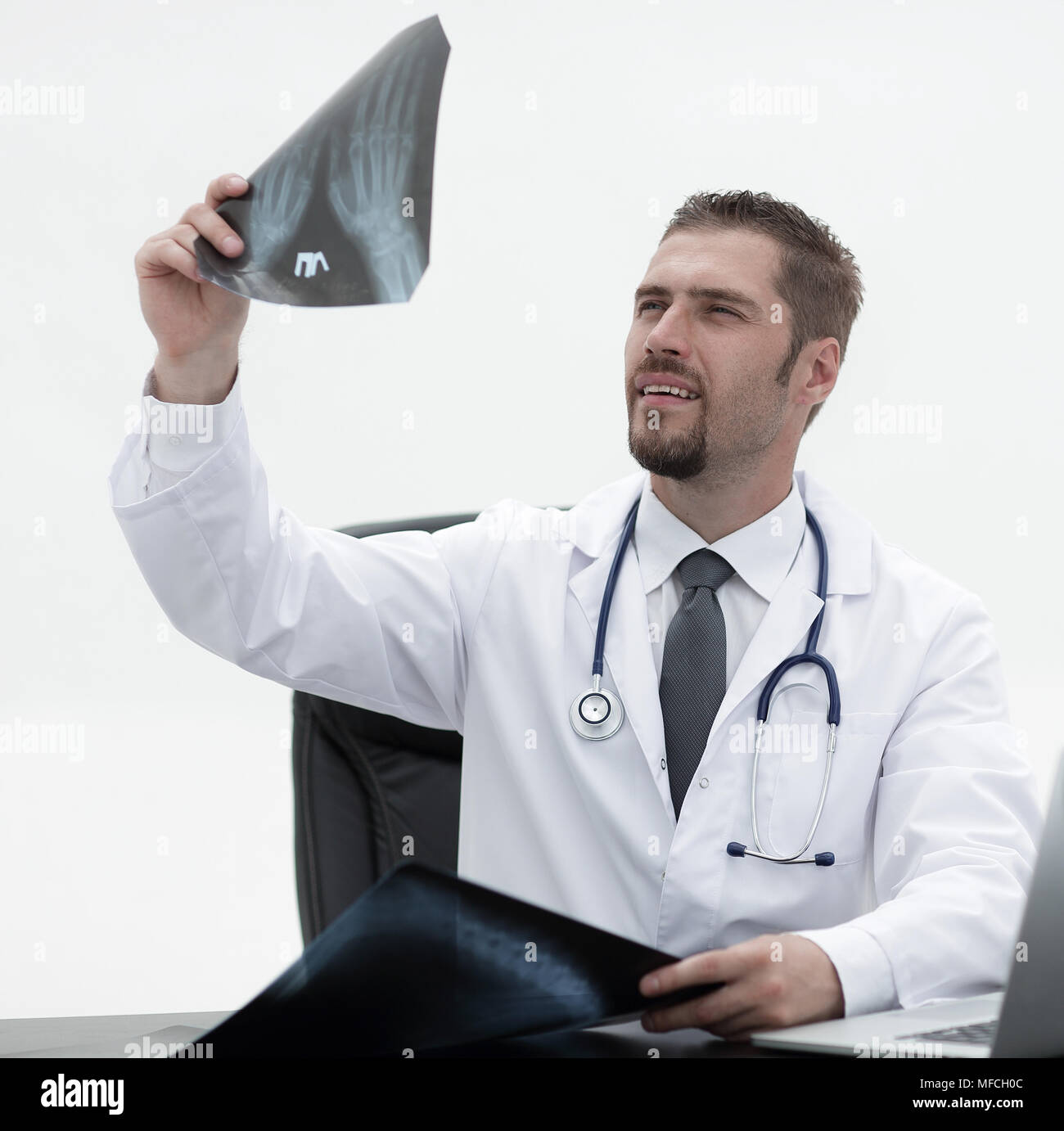 doctor examines an x-ray,sitting behind a Desk Stock Photo - Alamy