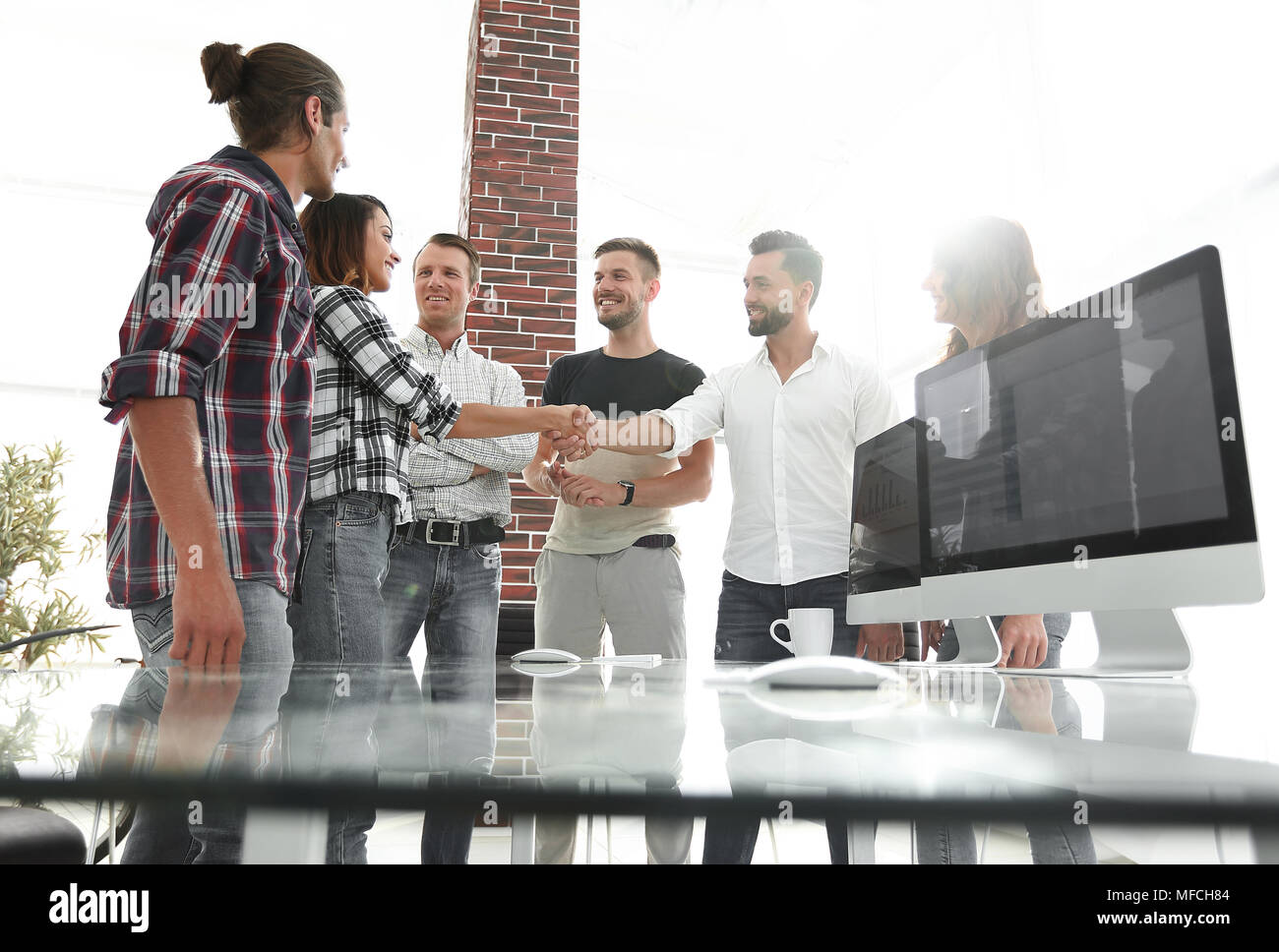 handshake partners in the creative office Stock Photo - Alamy